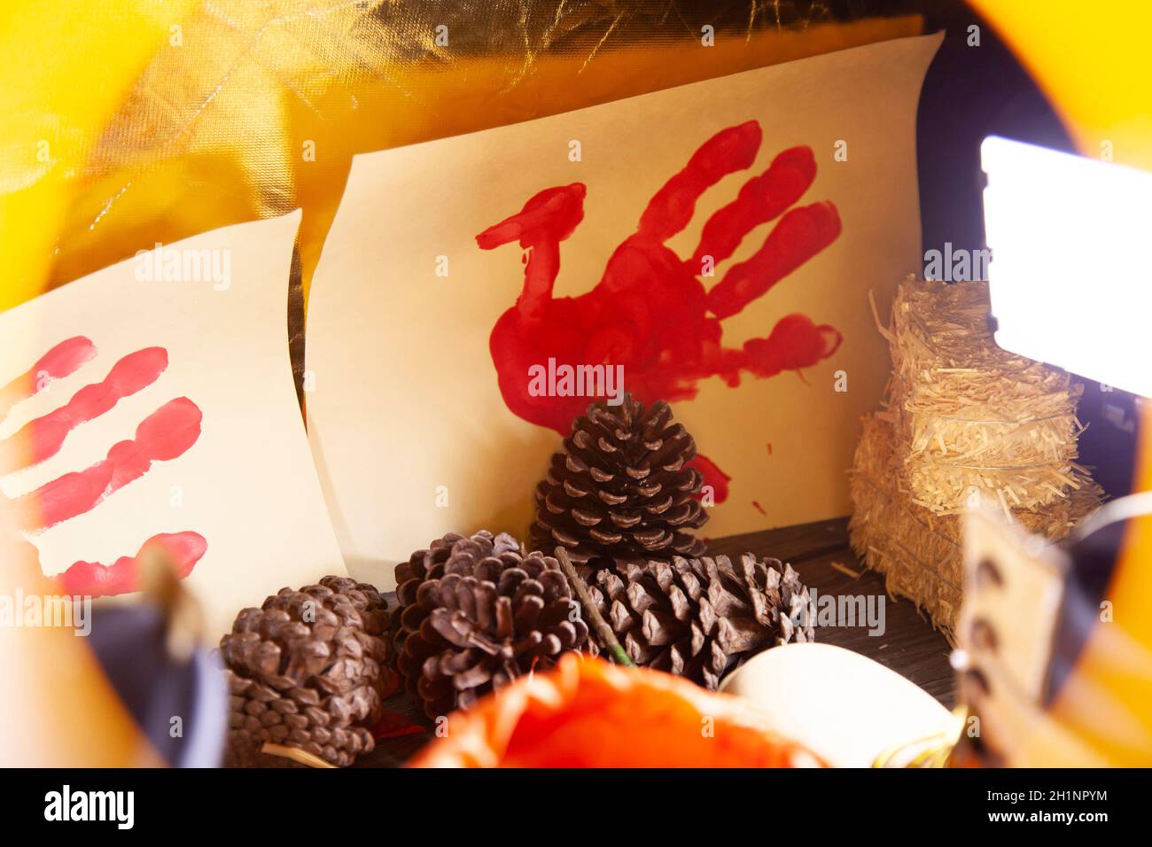 Red hand turkey on vanilla construction paper with hay and pinecones ...
