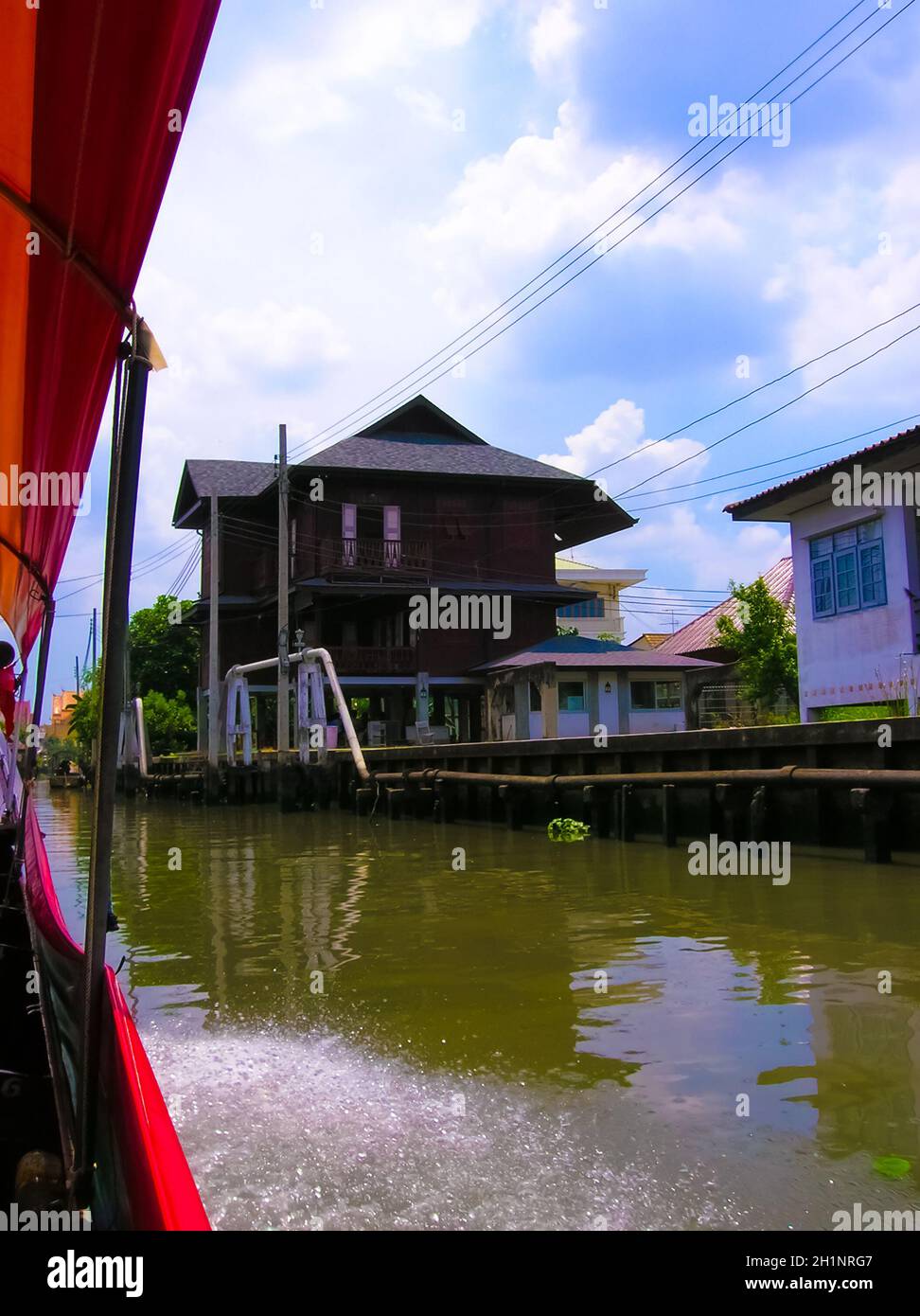 Wooden slums on stilts on the riverside of Chao Praya River in Bangkok ...