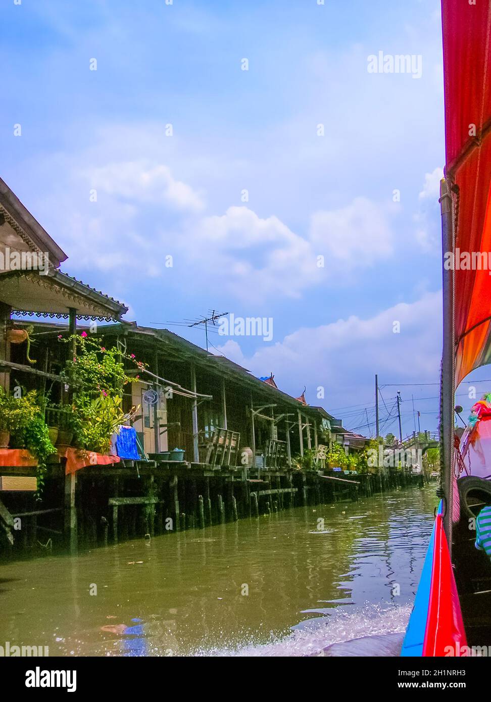 Wooden slums on stilts on the riverside of Chao Praya River in Bangkok ...
