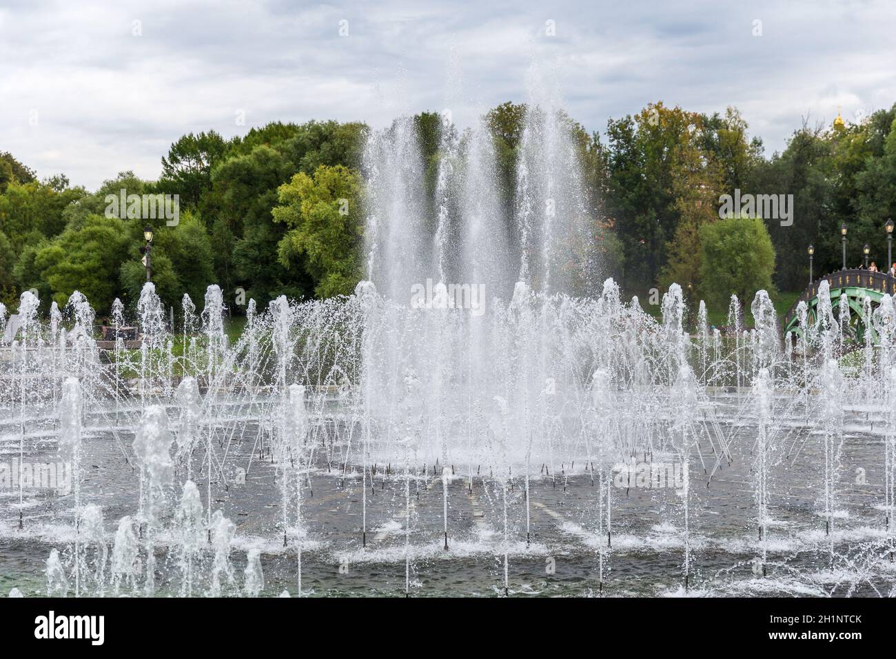Splashing water of fountain injection from ground in public park ...