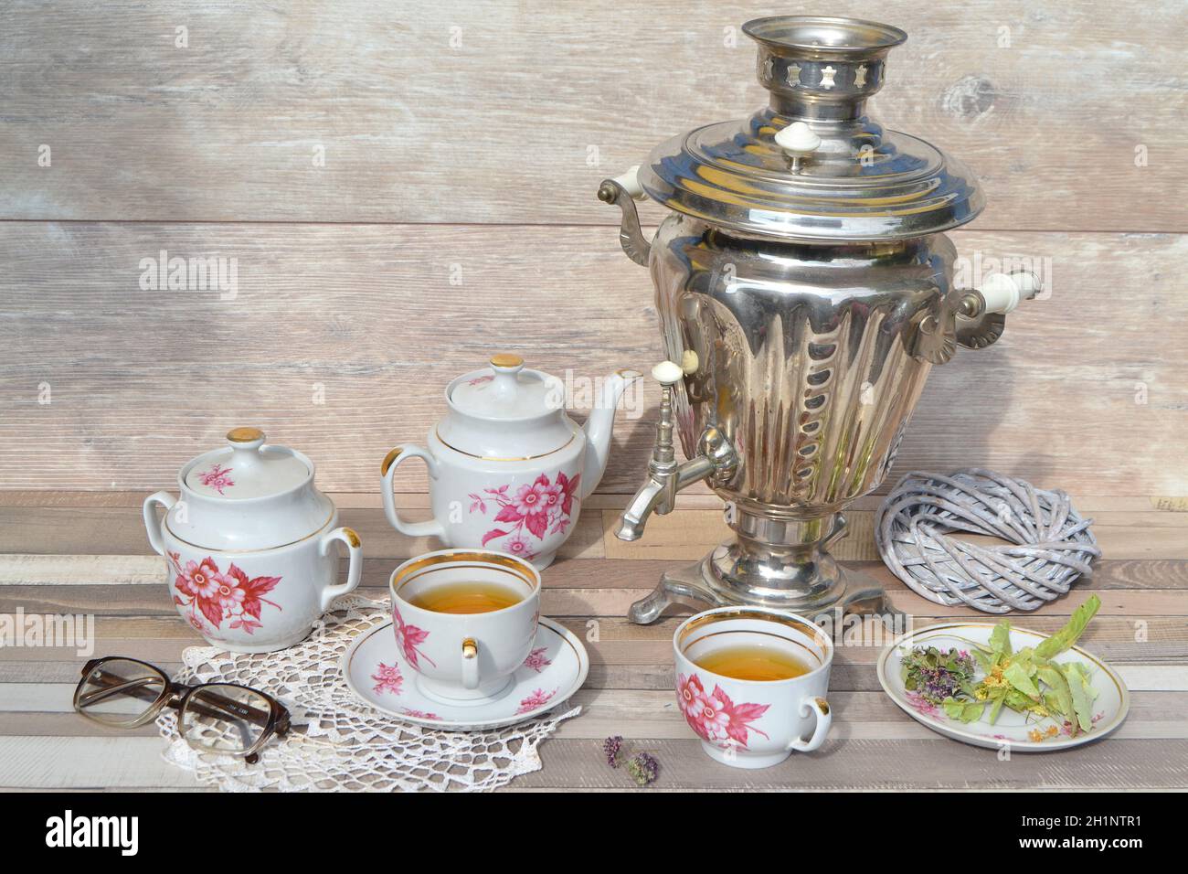 Tea party old samovar, cups and teapot on a summer day. Russian ...