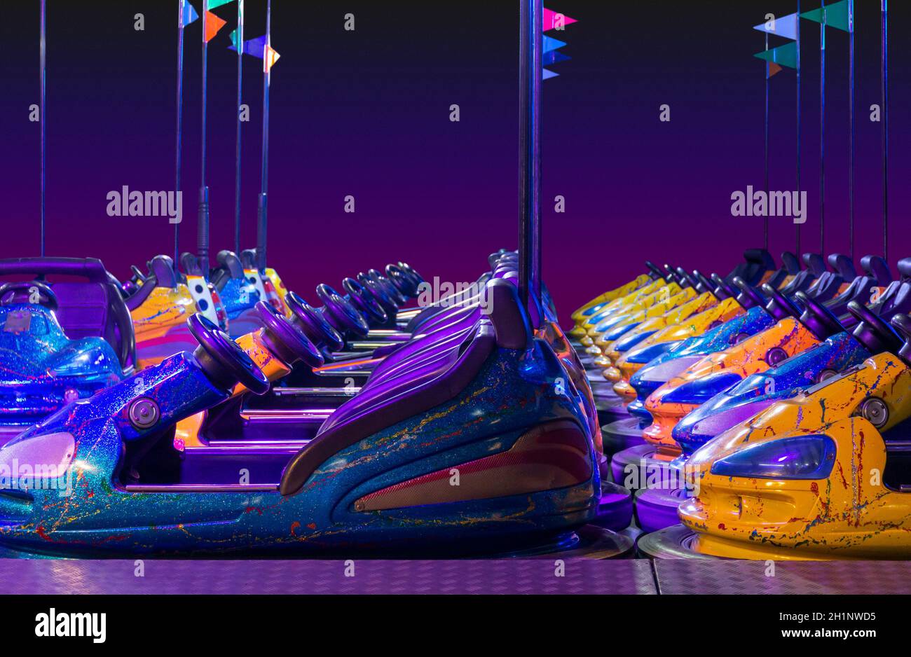 rowed colorful bumper cars in front of gradient colored back Stock ...