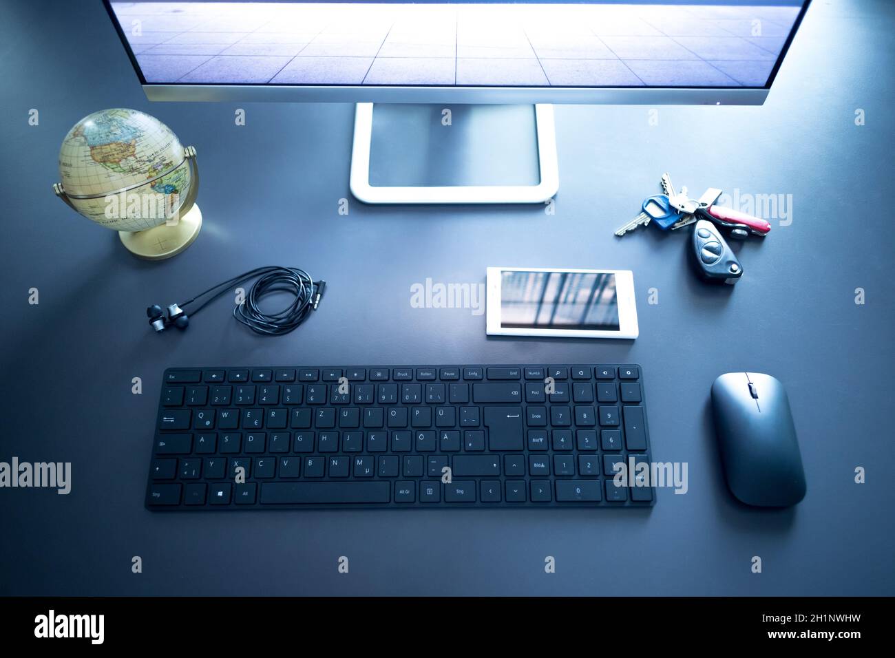 Workplace of a freelancer: Arrangement of computer, keyboard, earphones ...