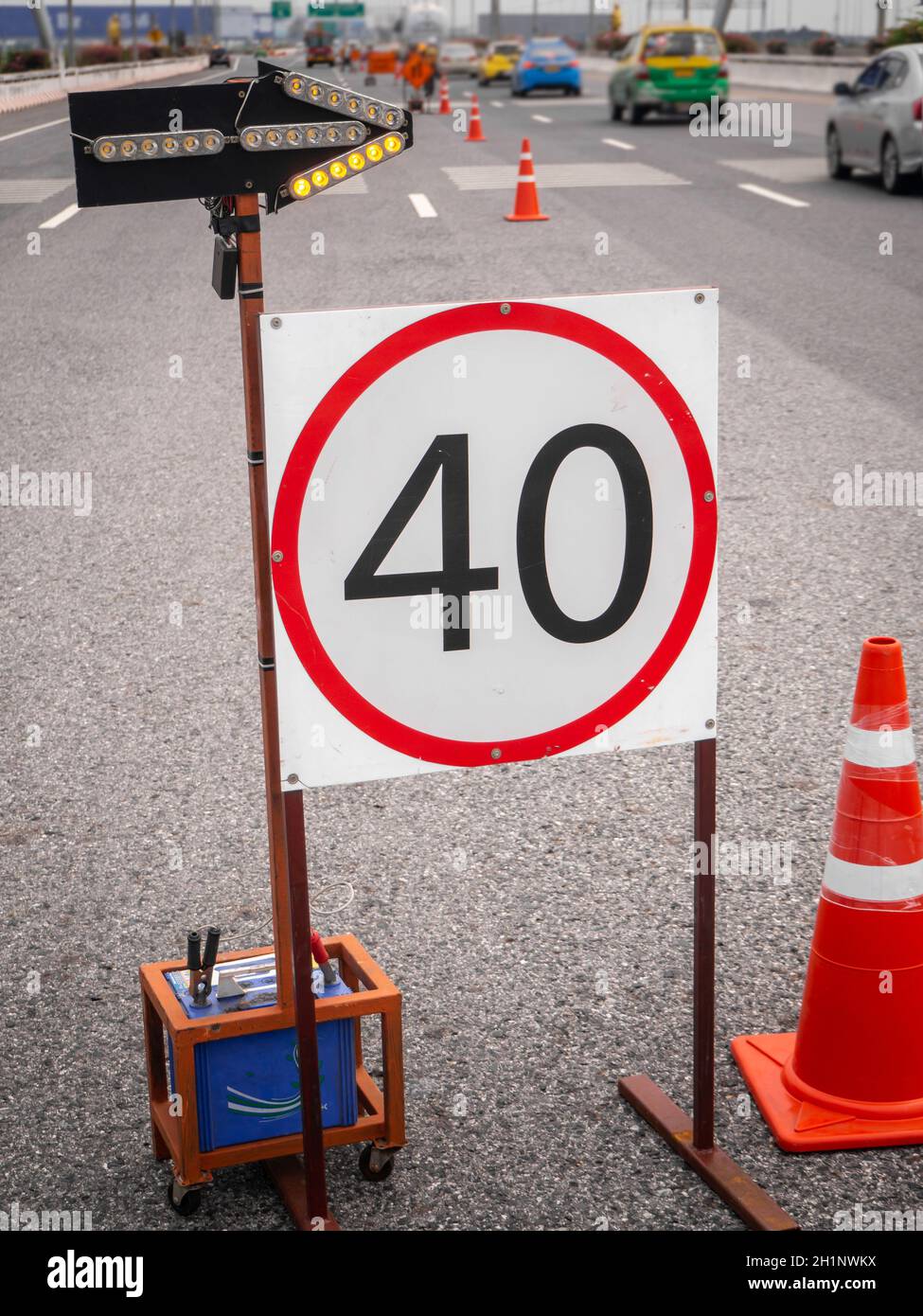The signs repairs road and worker on the road Stock Photo - Alamy
