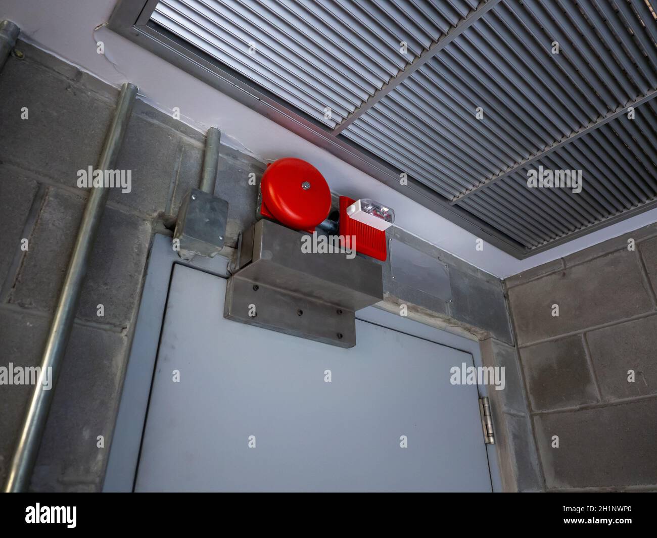 Electric red fire ring bell alarm on the wall in system room Stock ...