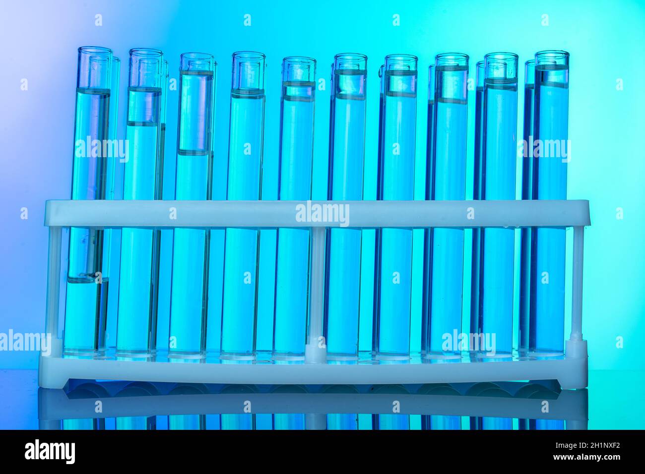 Row of test tubes with liquids on blue and green toned background Stock ...