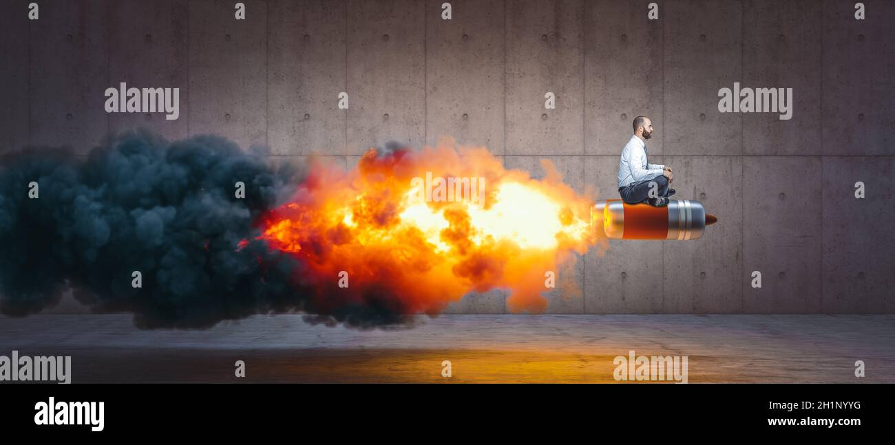 man sitting on a rocket with flames and smoke. concept of success and ...
