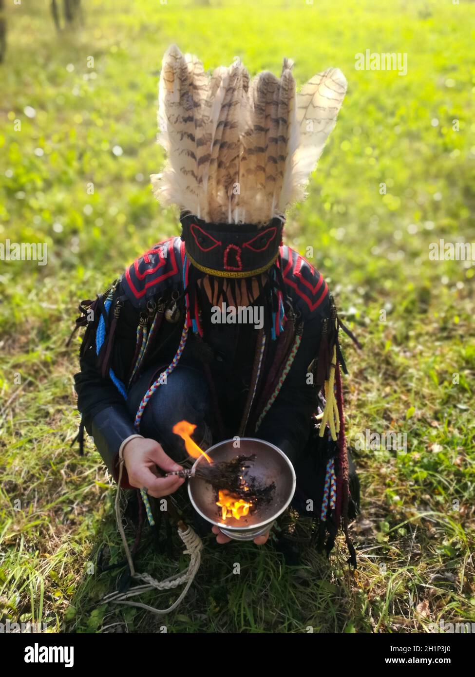The shaman performs a ritual with the burning of grass Stock Photo - Alamy