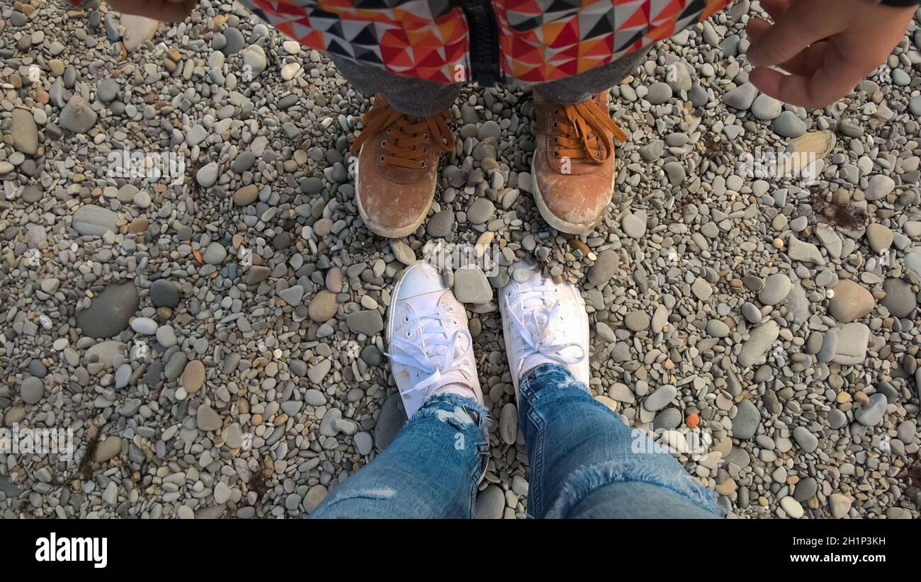 Legs in sneakers opposite each other. Street clothes and shoes Stock ...