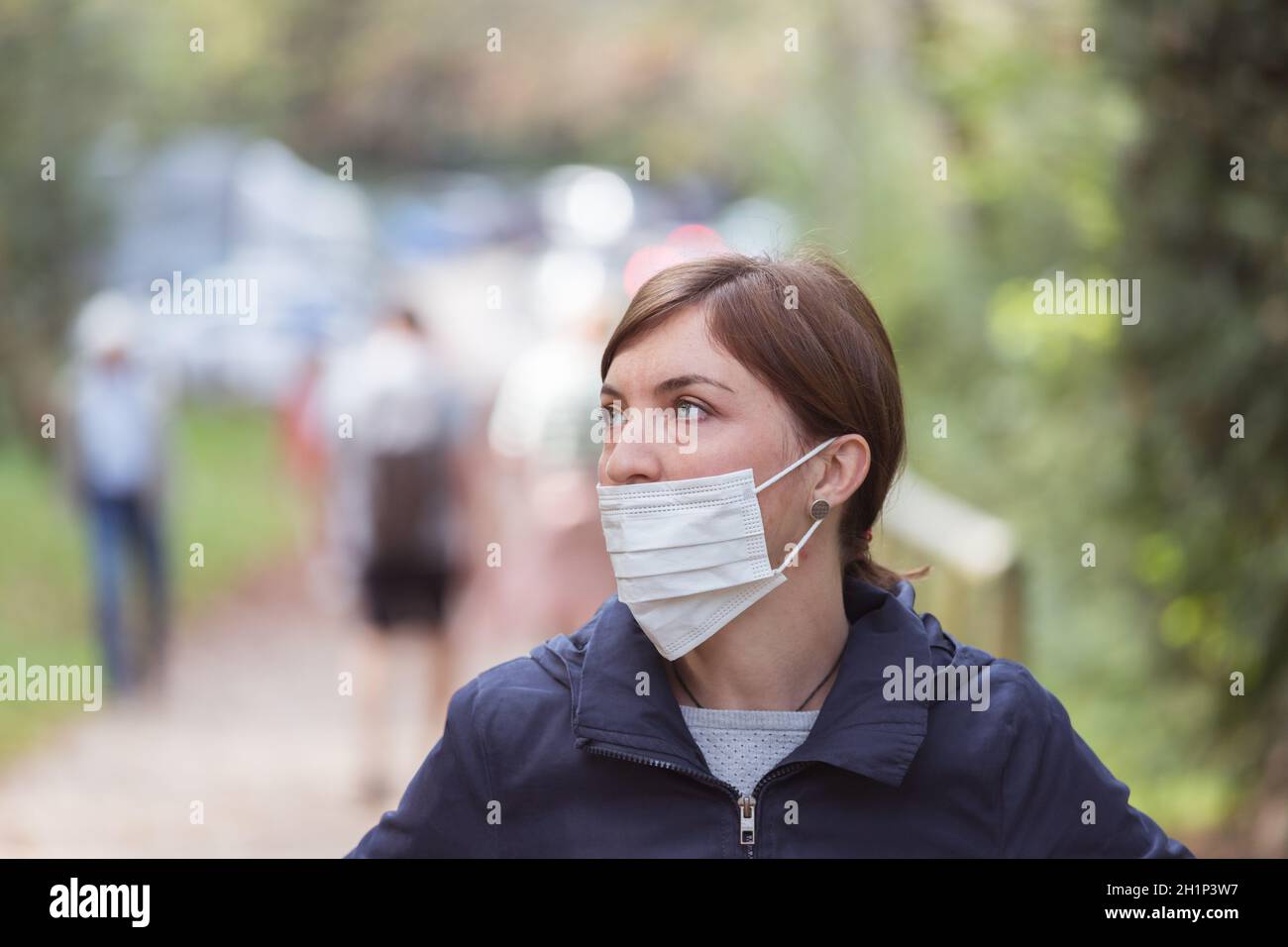 Young woman is wearing face mask wrong, nose uncovered Stock Photo - Alamy