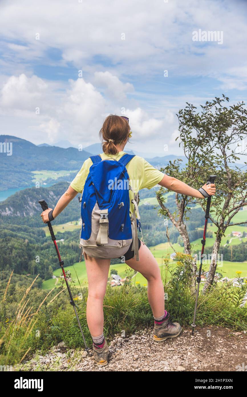 Young slim backpacker tourist girl is enjoying the view on rocky ...