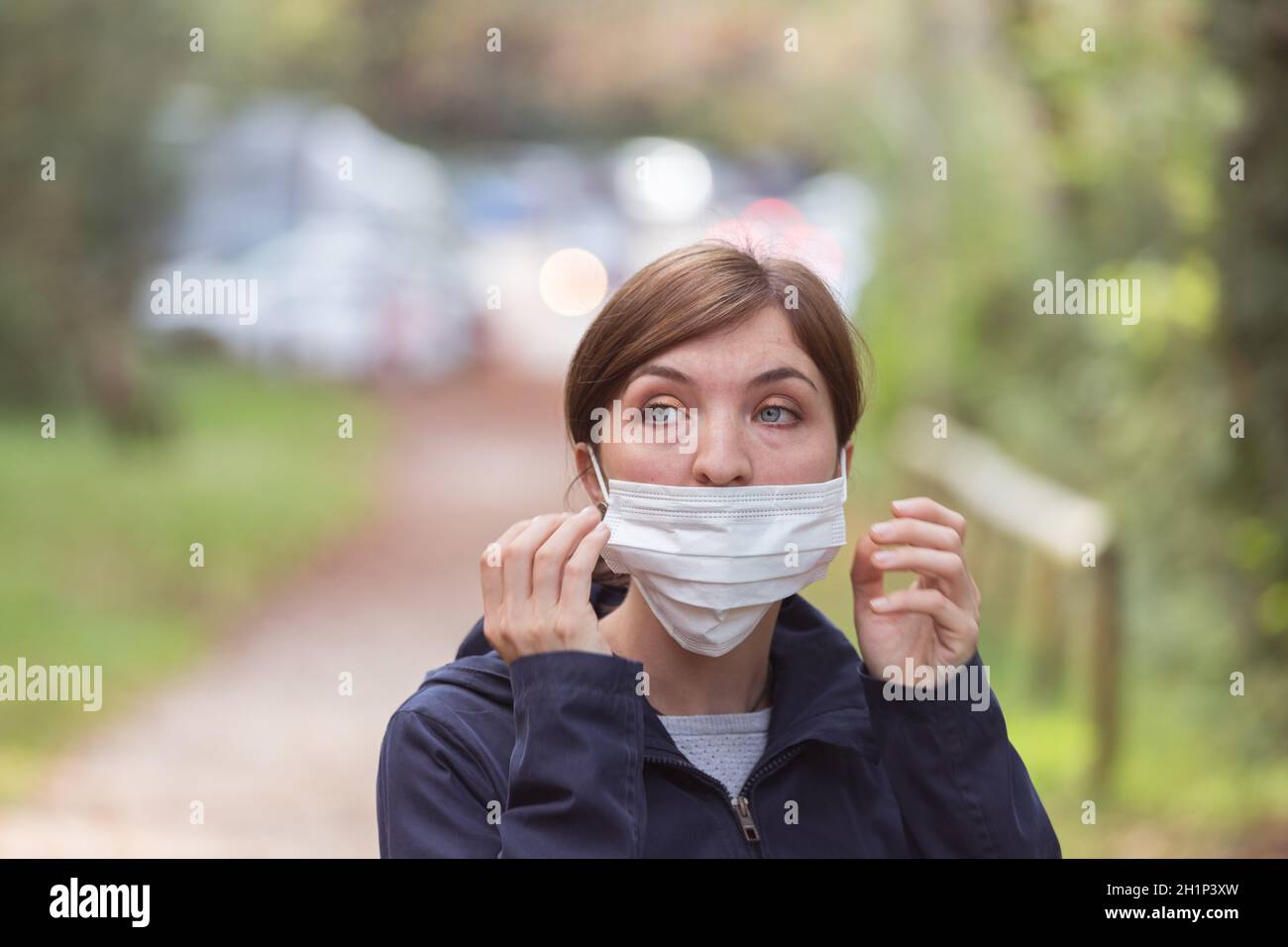 Young woman is wearing face mask wrong, nose uncovered Stock Photo - Alamy