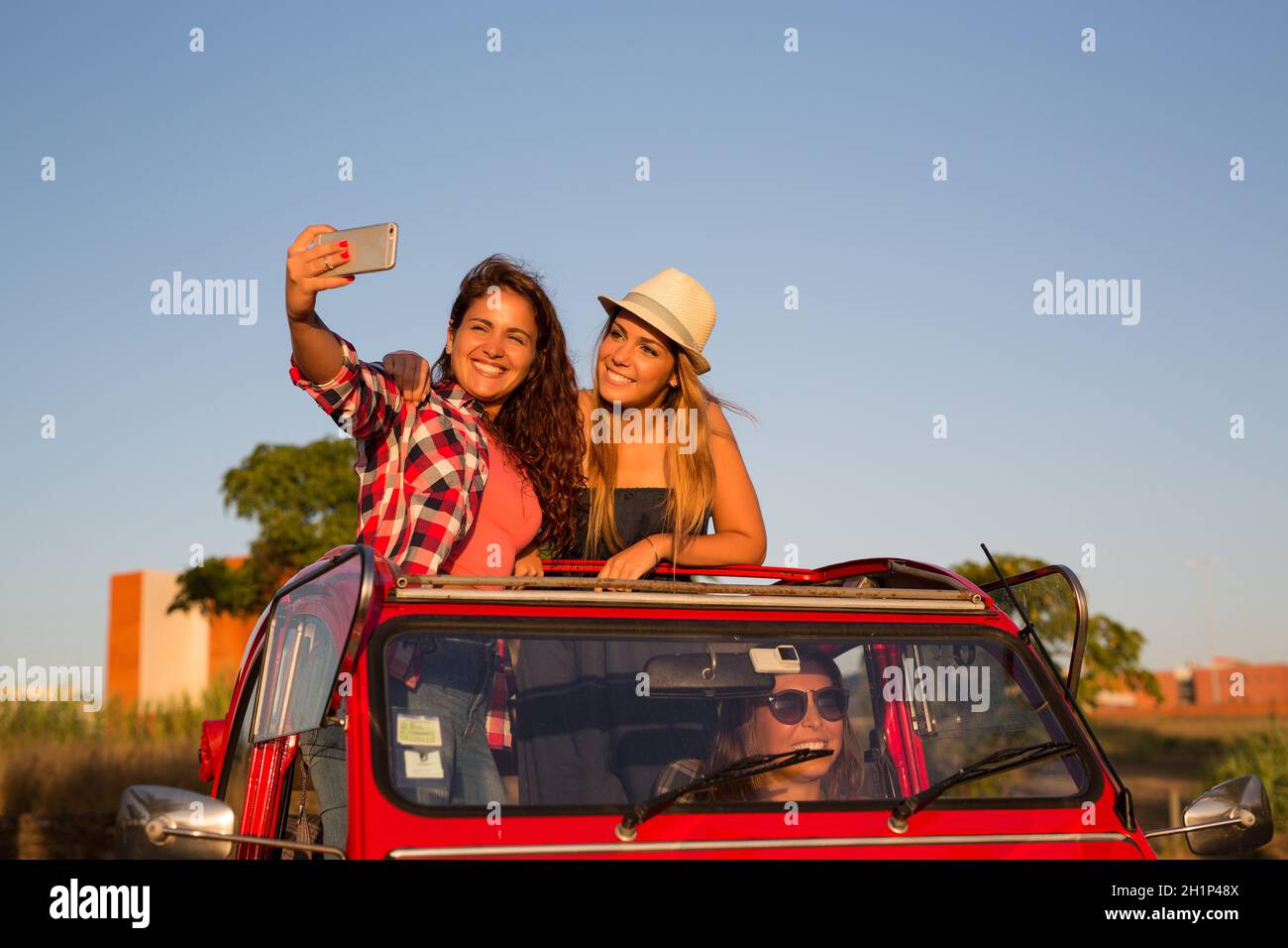 Group of friends on a roadtrip through countryside Stock Photo - Alamy