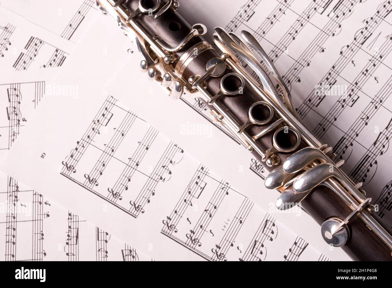 Photograph of a clarinet isolated over sheet music Stock Photo - Alamy