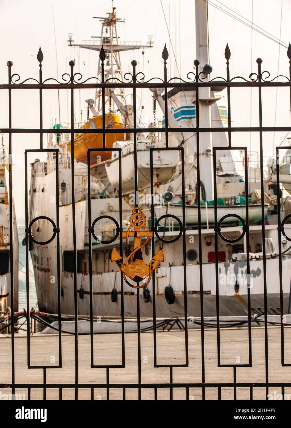 Seaport fence featuring an anchor with a blurred background of ships ...