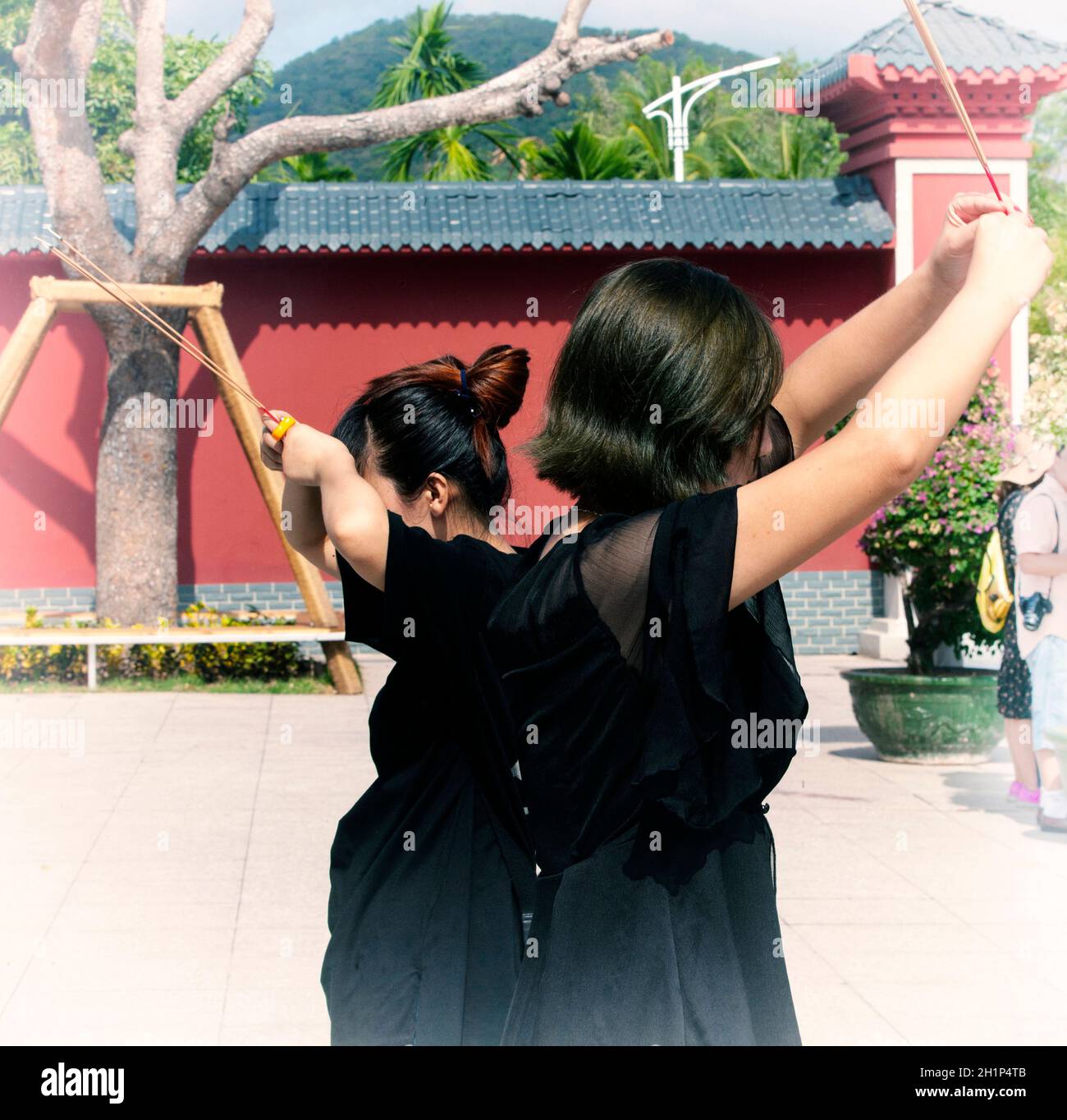 girls Chinese women praying with candles Stock Photo - Alamy