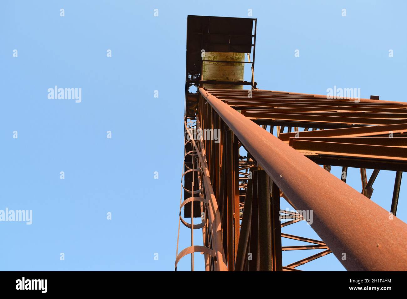 The old rusty water tower tilted. An old rustic communal communication ...