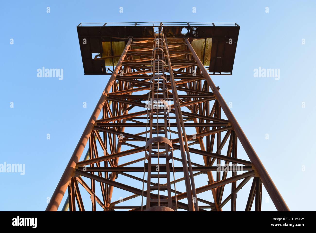 The old rusty water tower tilted. An old rustic communal communication ...