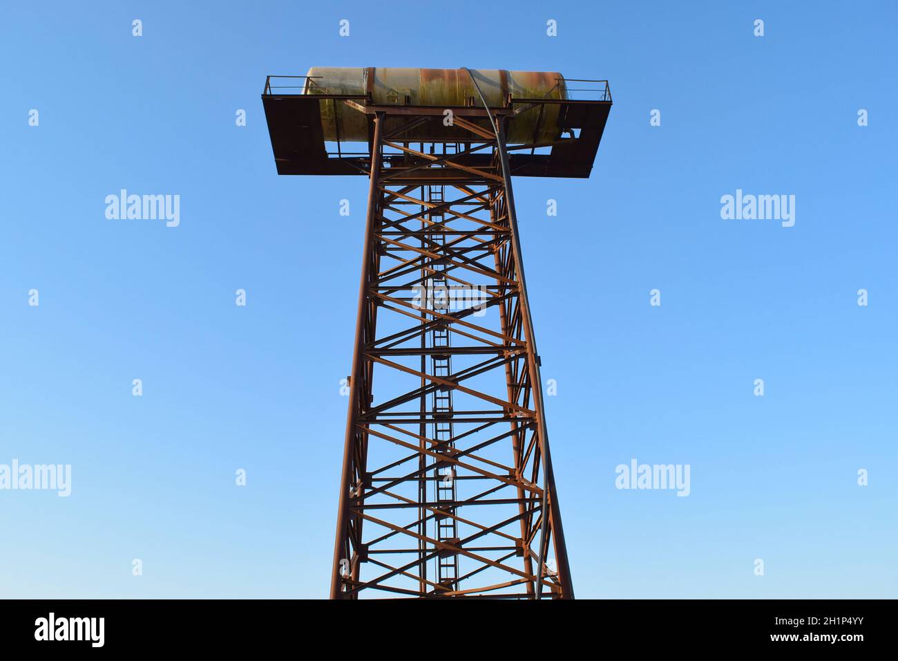 Rusty water tower. An old rustic communal communication Stock Photo - Alamy