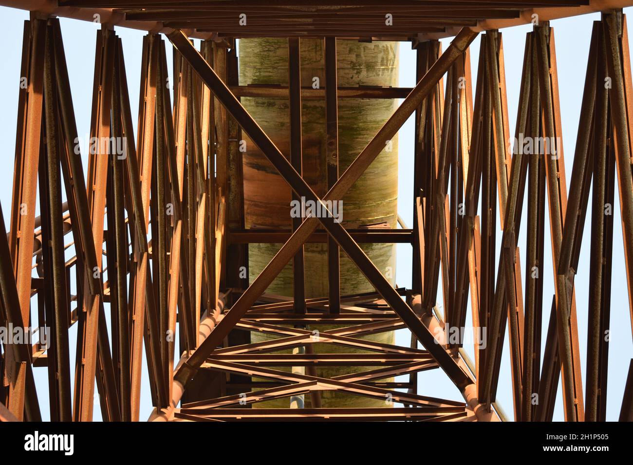 The old rusty water tower tilted. An old rustic communal communication ...