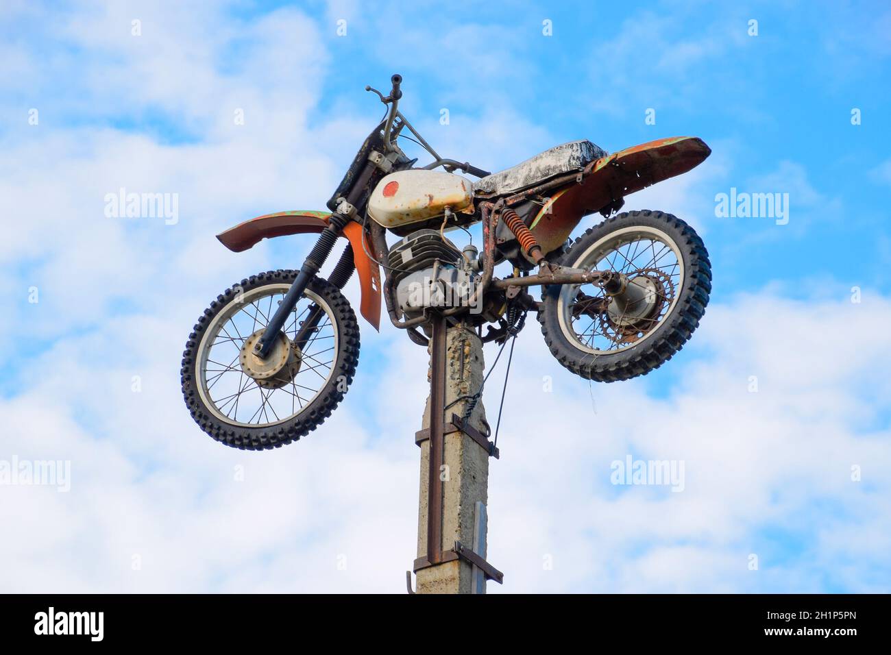 Motorcycle on the pedestal. A light motorbike on a pole, put up as a ...