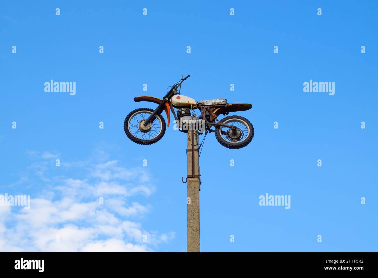 Motorcycle on the pedestal. A light motorbike on a pole, put up as a ...
