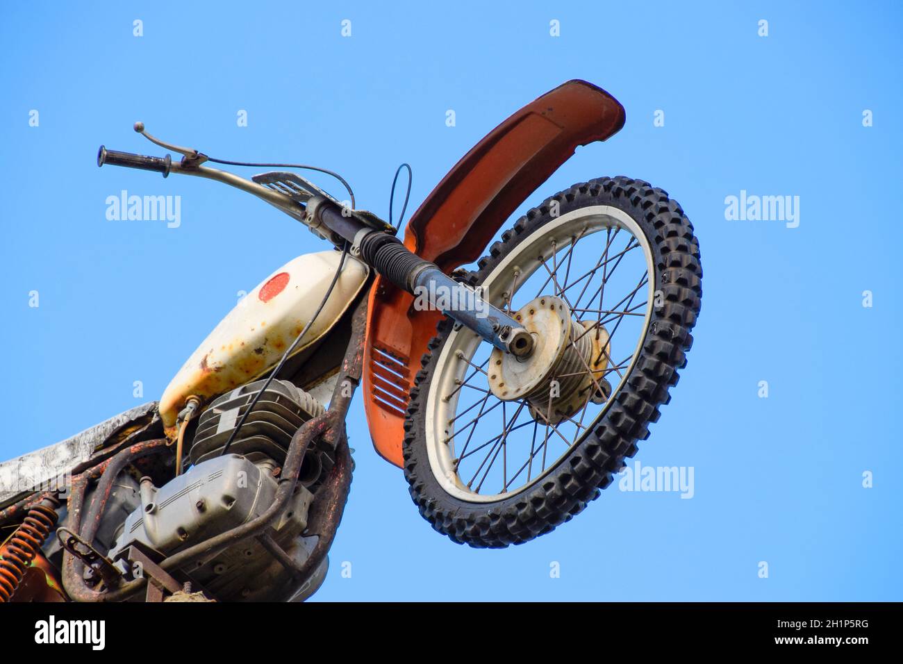 Motorcycle on the pedestal. A light motorbike on a pole, put up as a ...