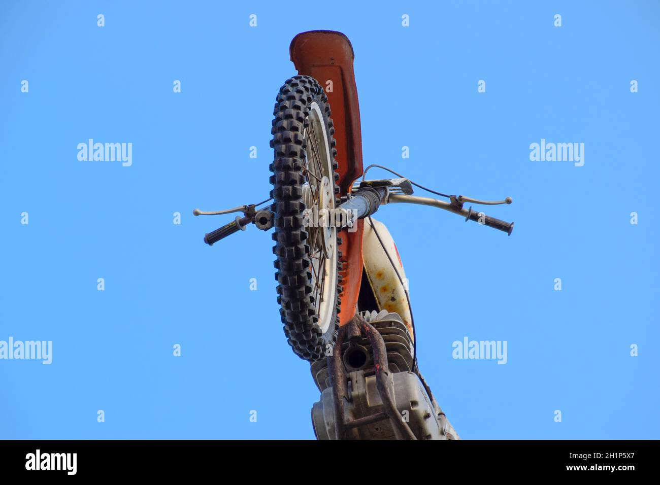 Motorcycle on the pedestal. A light motorbike on a pole, put up as a ...