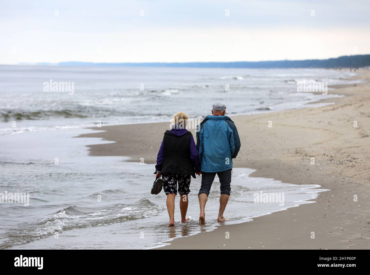 Active and healthy lifestyle. Walking on a sandy beach sea shore Stock ...