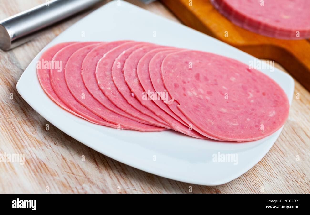 Slices of sausage mortadella from turkey on board Stock Photo - Alamy