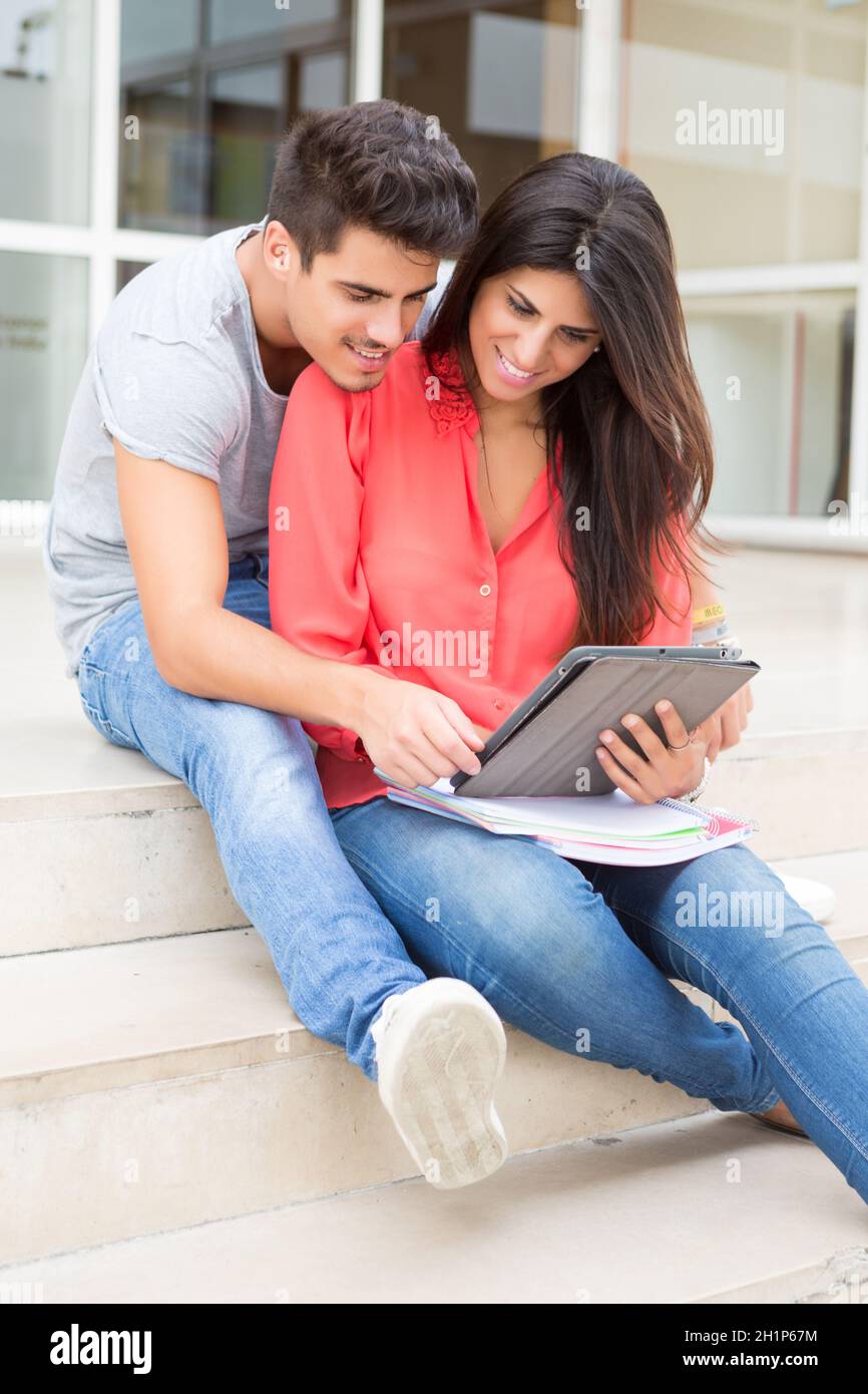 Couple of happy students at the university campus Stock Photo - Alamy