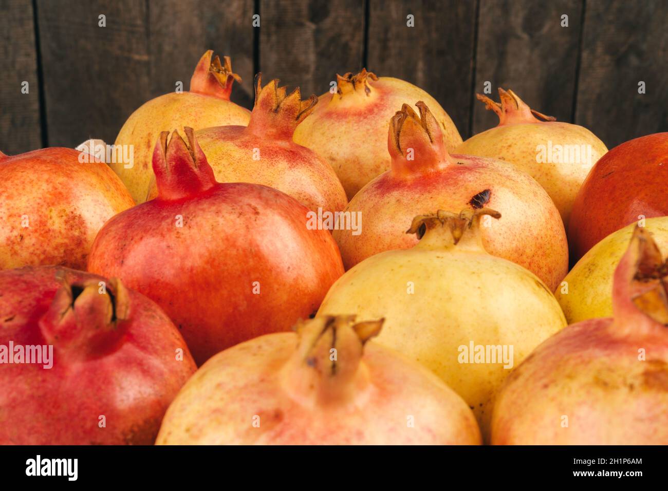 Group of pomegranate fruits close up background Stock Photo - Alamy