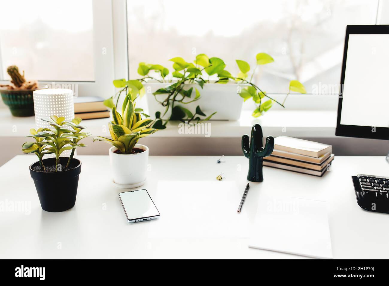 Smartphone on white table, work from home, office stuff. High quality ...