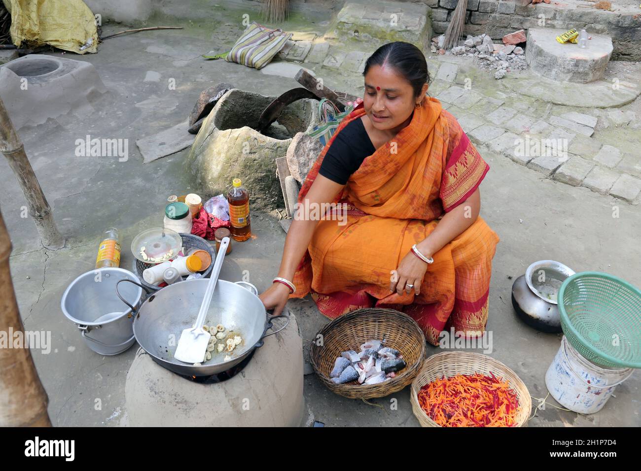 Traditional way of making food on open fire in old kitchen in a village ...