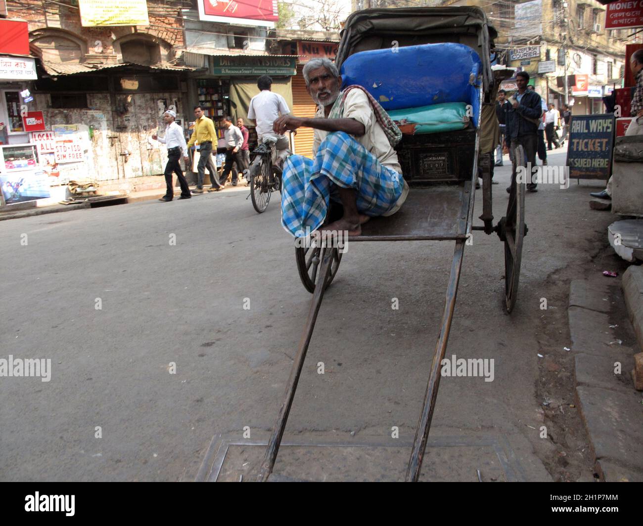 Man wait for passengers on their rickshaw in Kolkata, India Stock Photo ...