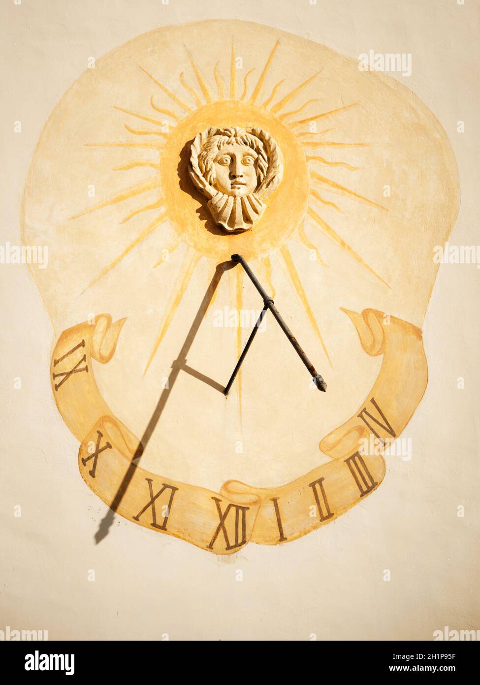 Sundial on a yellow wall Stock Photo - Alamy