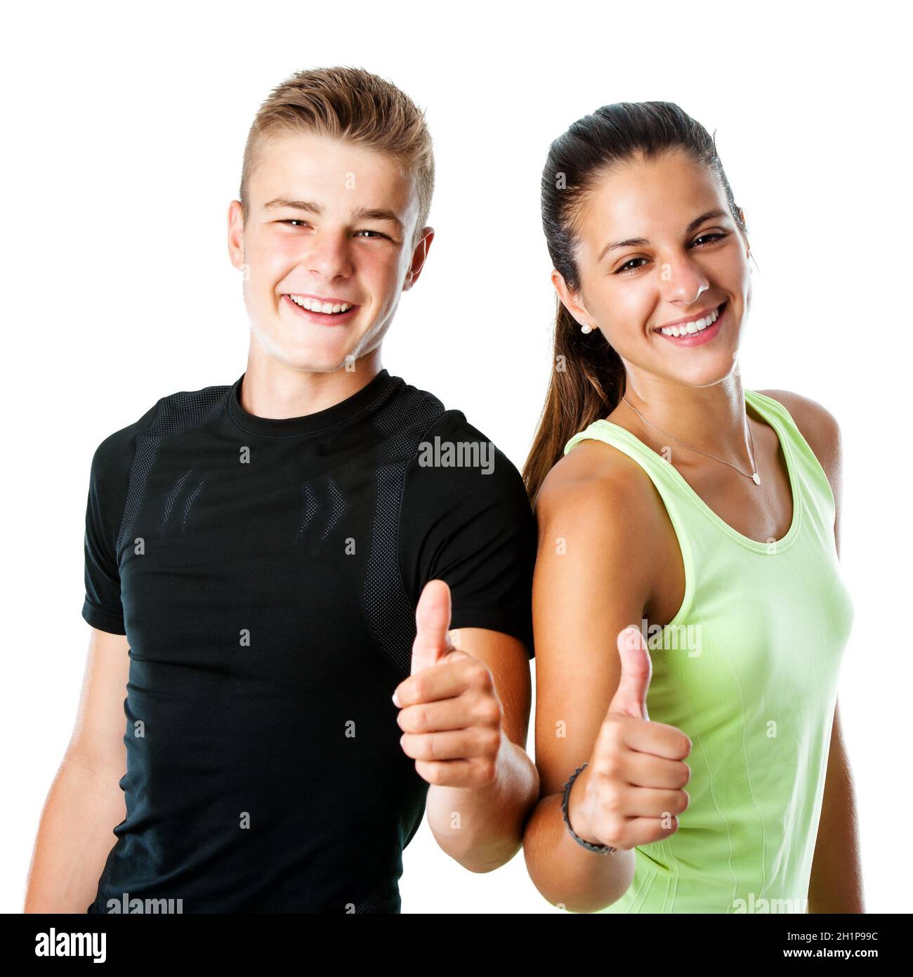 Close up portrait of active teen couple in sportswear doing thumbs up ...
