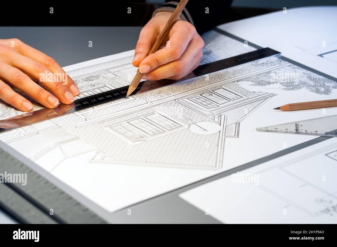 Macro close up of quantity surveyor working on architectural layout ...