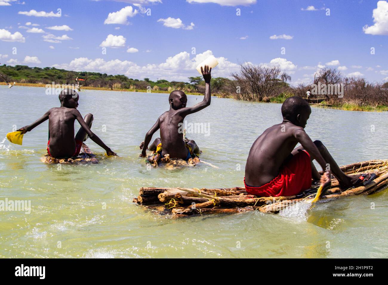Boys doing fishing are seen sailing in a traditional balsa wood raft in ...