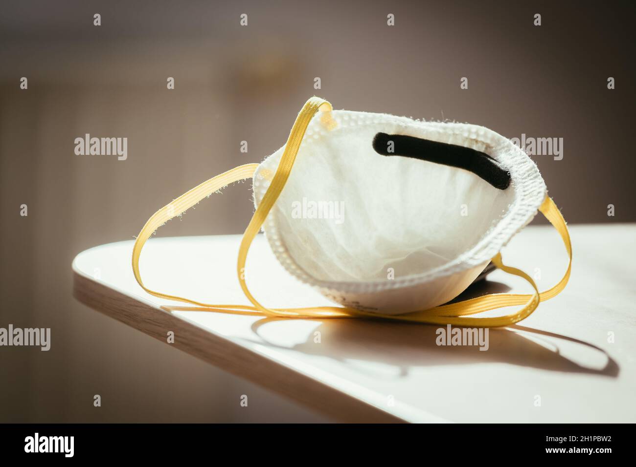 Breathing mask lying on a table. Flue and corona season Stock Photo - Alamy