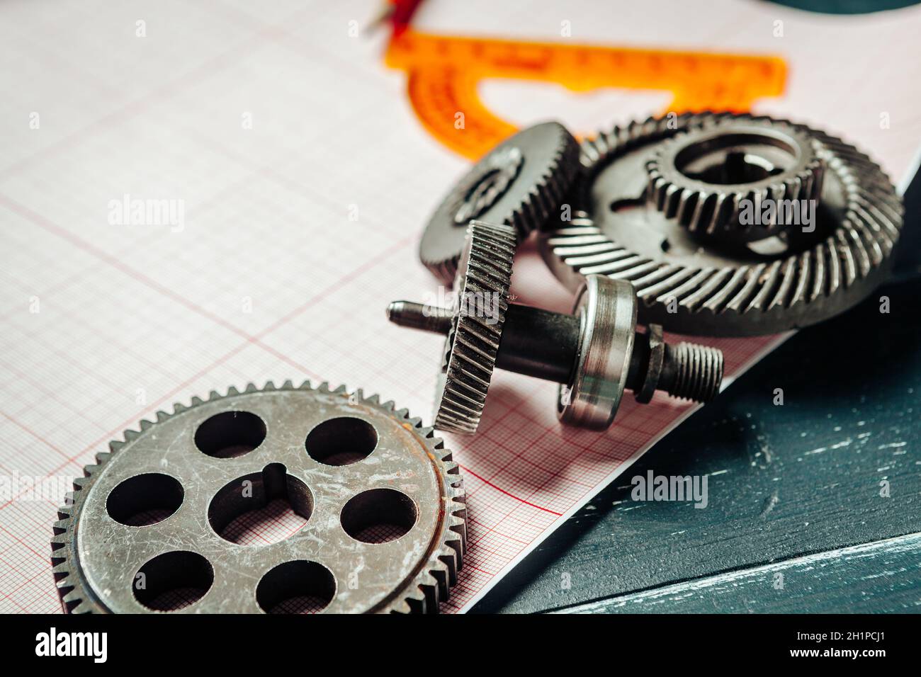Car parts on graph paper close up. Engineering concept Stock Photo - Alamy