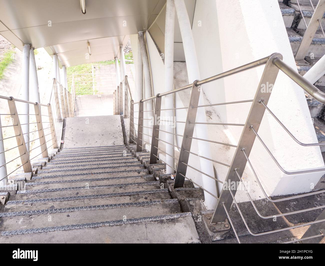 staircase for descending from footbridge. The concrete overpass for ...