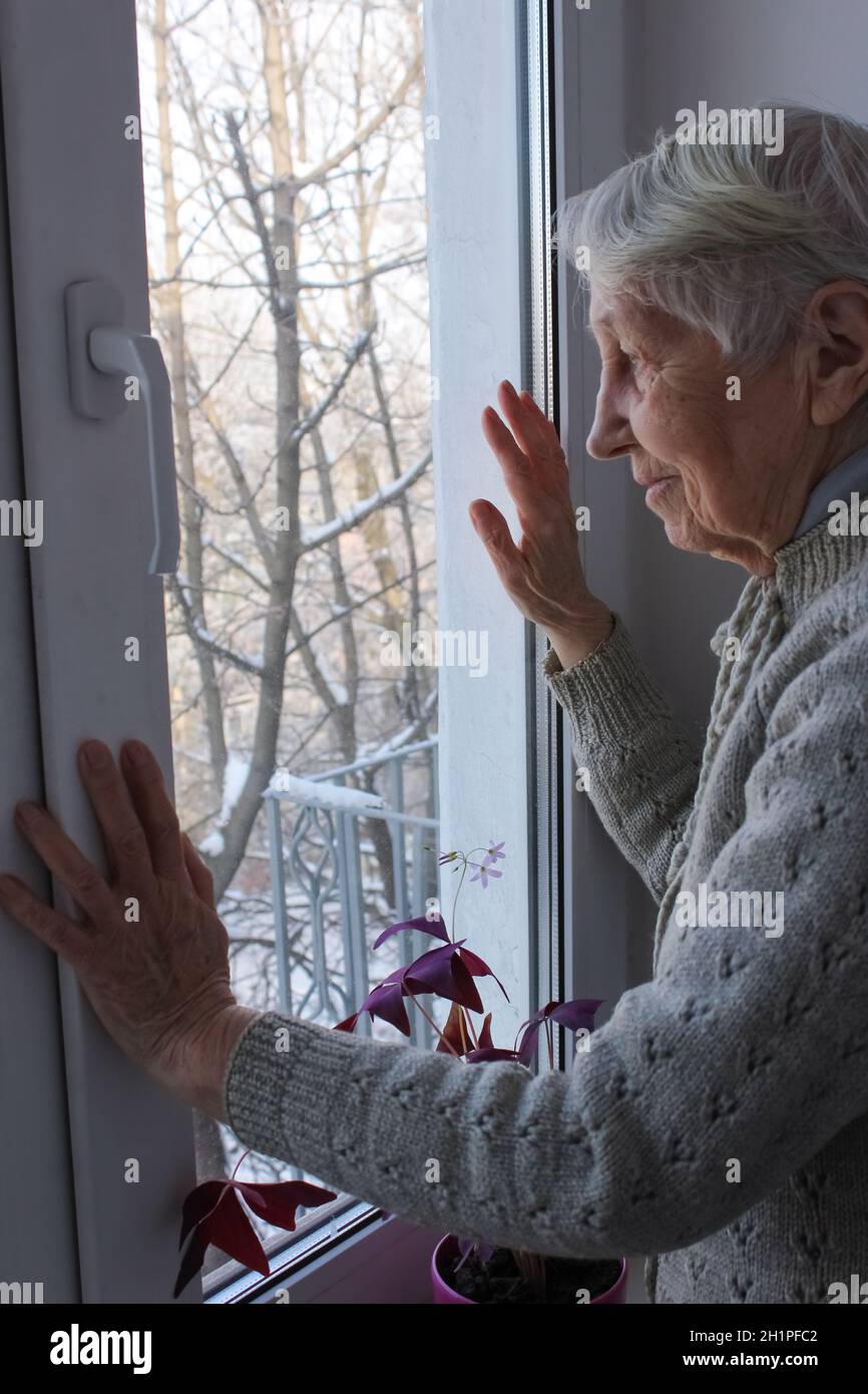 Old lonely woman near the window at home Stock Photo - Alamy