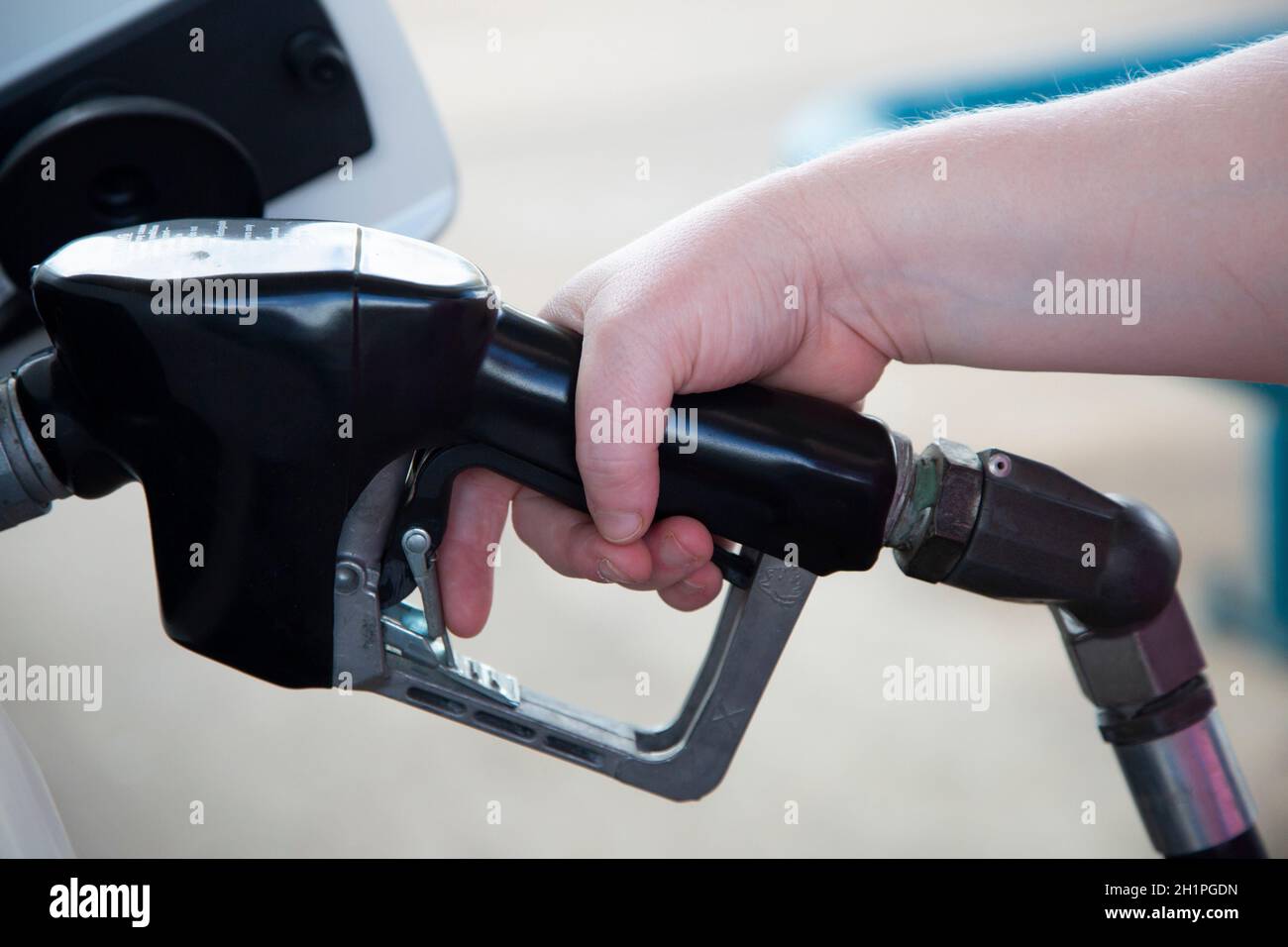 Woman's hand pushing a generic gas pump handle Stock Photo - Alamy
