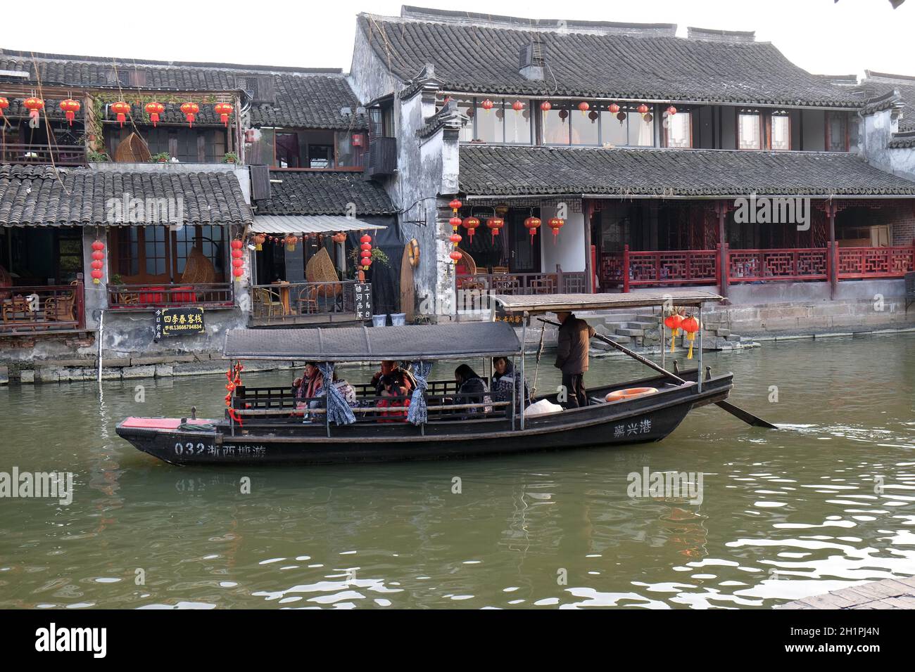 Tourist boats on the water canals of Xitang Town in Zhejiang Province ...