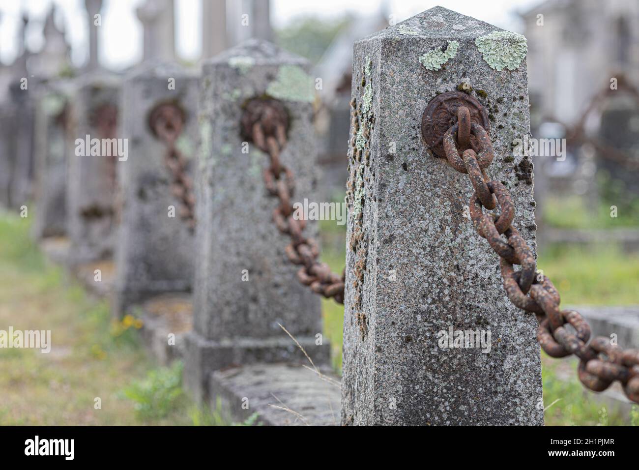 Old rusty chain connected to a concrete post Stock Photo - Alamy