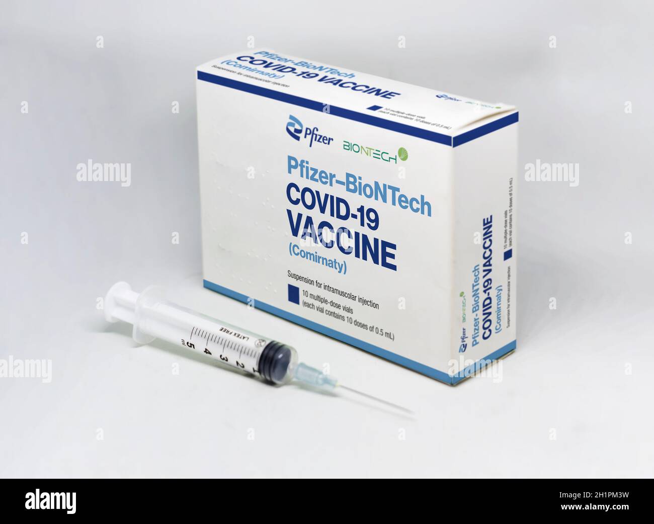 New York USA, february 5th 2021: A syringe next to the Pfizer BioNTech ...