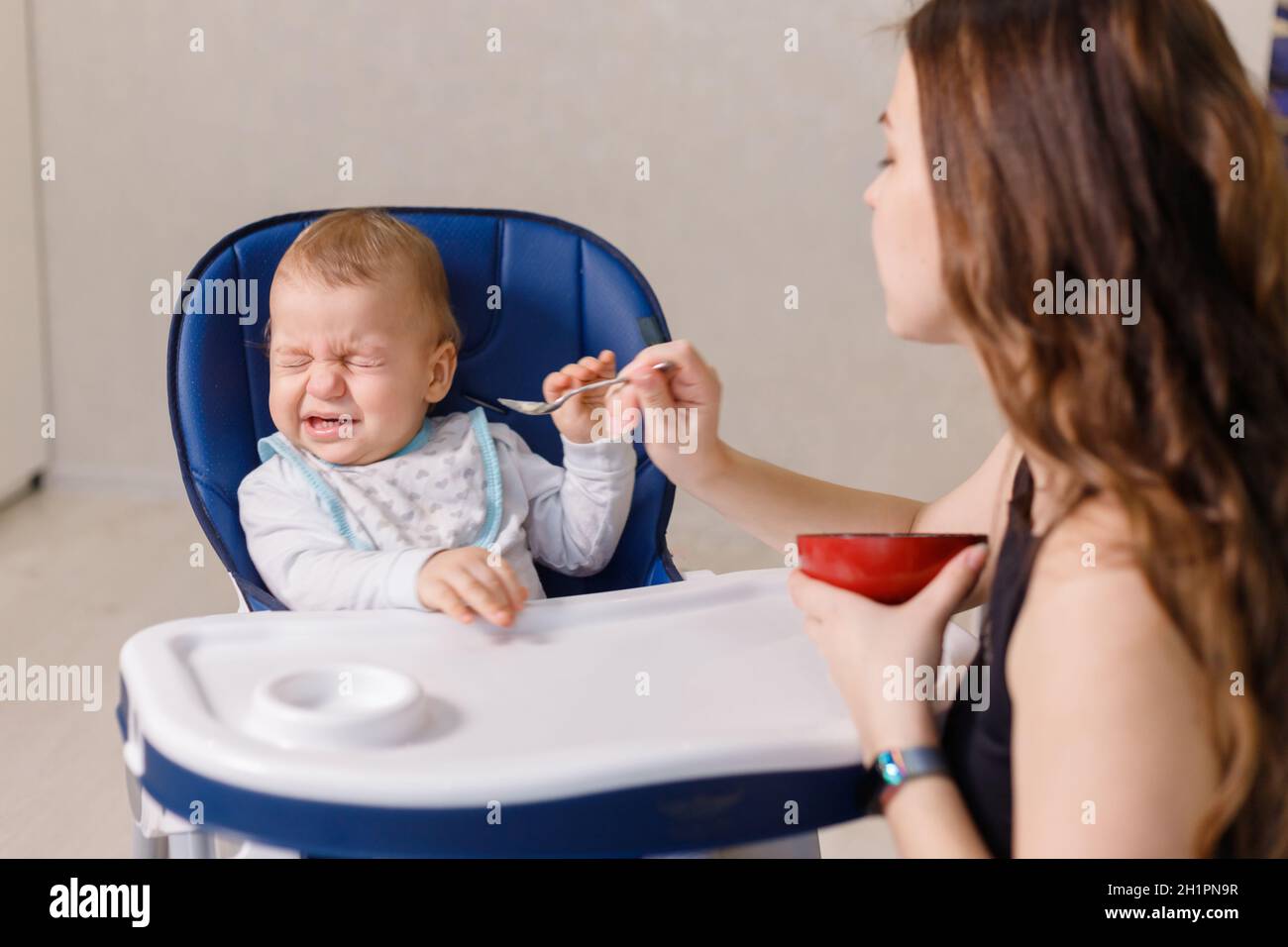 Naughty caucasian infant kid is fussy and refuses to eat Stock Photo ...