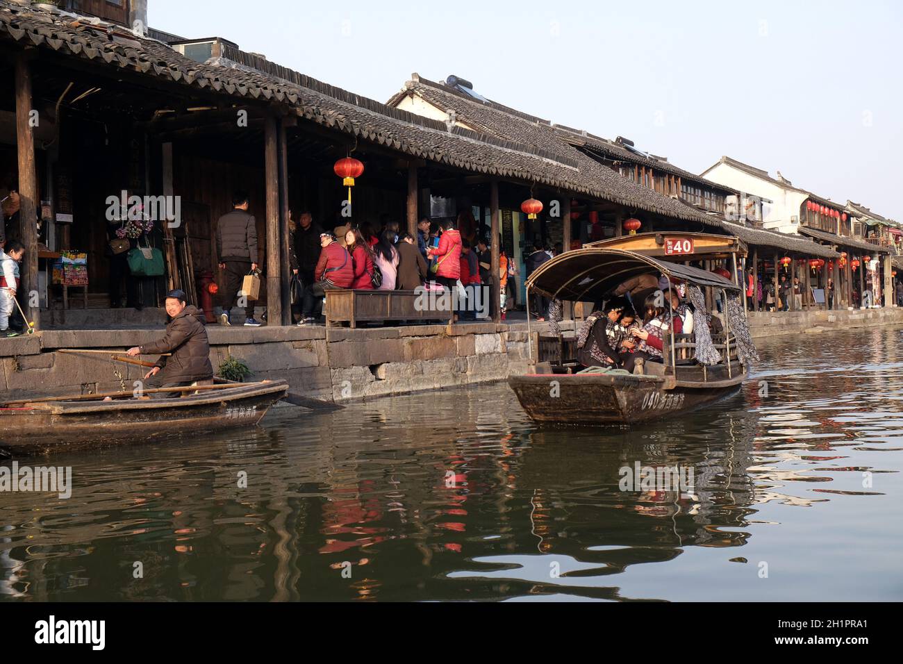 Tourist boats on the water canals of Xitang Town in Zhejiang Province ...