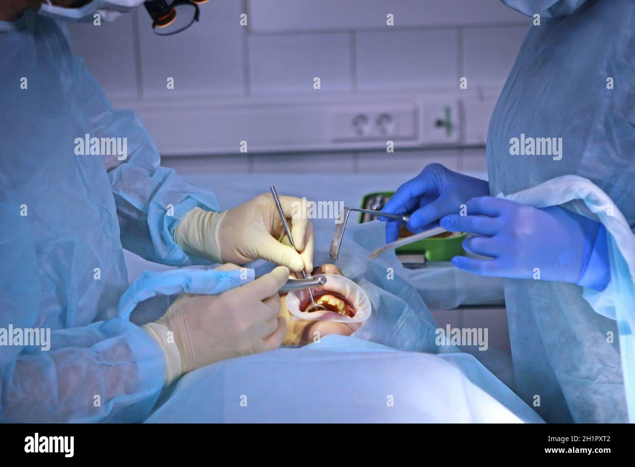 Surgery in a dental clinic. The surgeon and the assistant. Modern ...